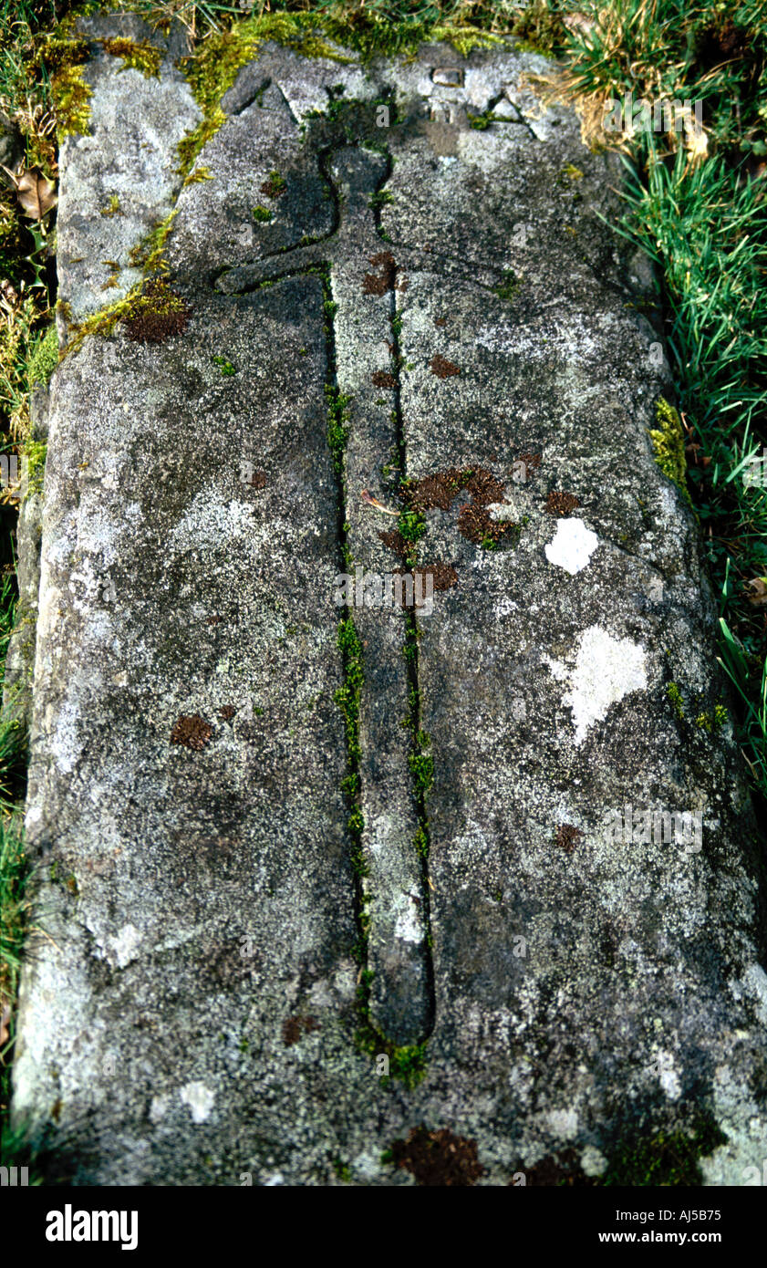 Carving of sword on tombstone Stock Photo - Alamy