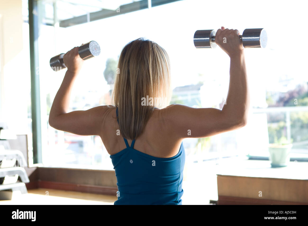 fit fitness female girl exercising in a gym. shoulder workout on a ball ...