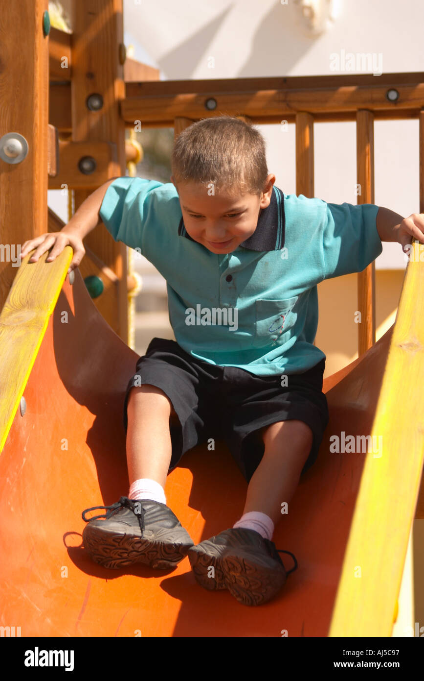 school child playing on slide Stock Photo - Alamy