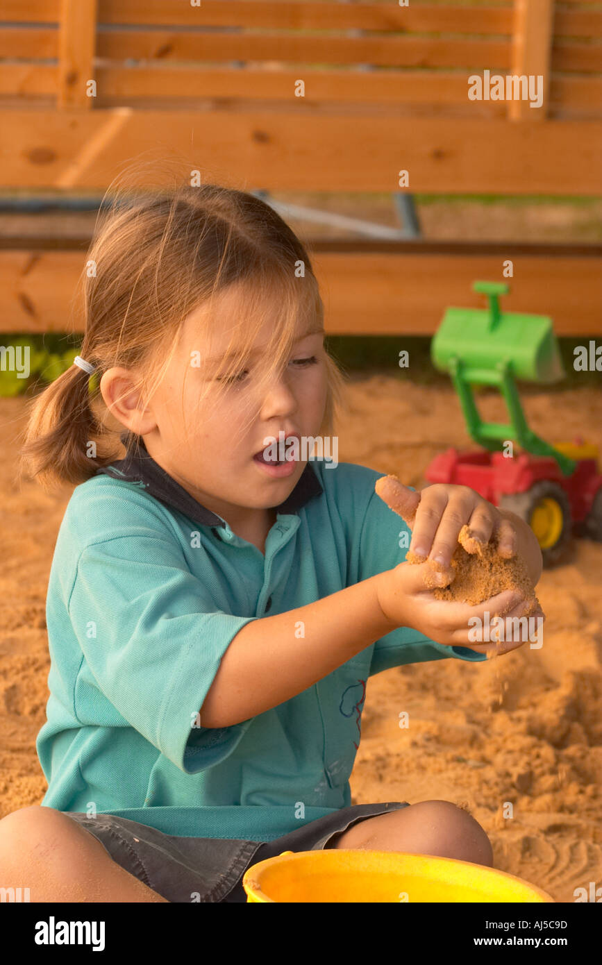 young girl playing in sandpit Stock Photo - Alamy