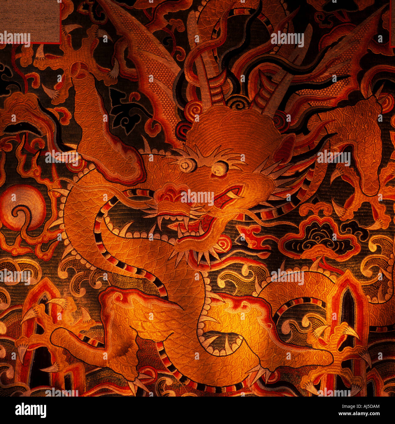 Fabric embroidery with pattern of a flying dragon Stock Photo - Alamy