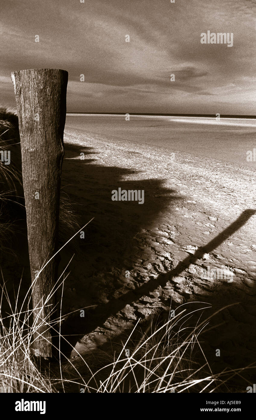 Black and white infrared landscape of a sunset on a North Norfolk shore ...