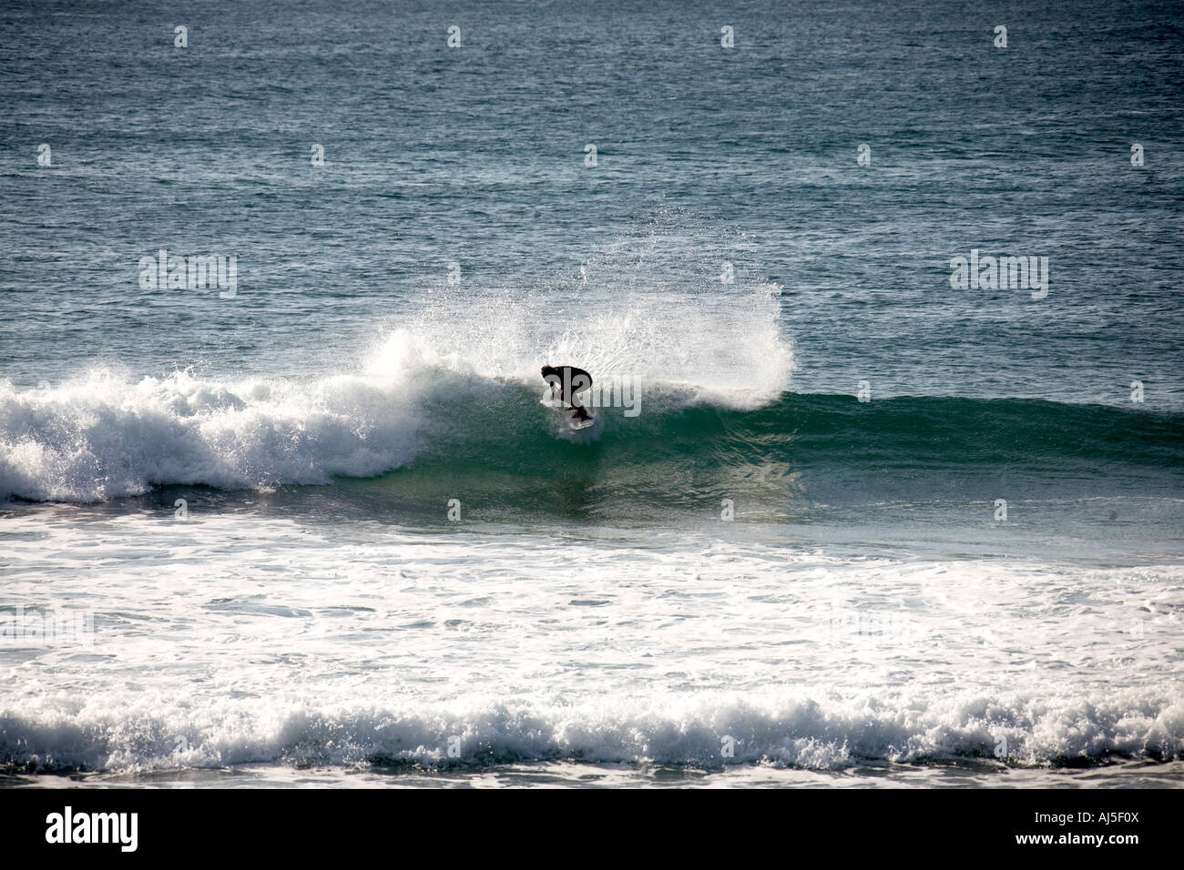 Surfer surfing on sea wave at Boambee Beach Coffs Harbour in New South ...