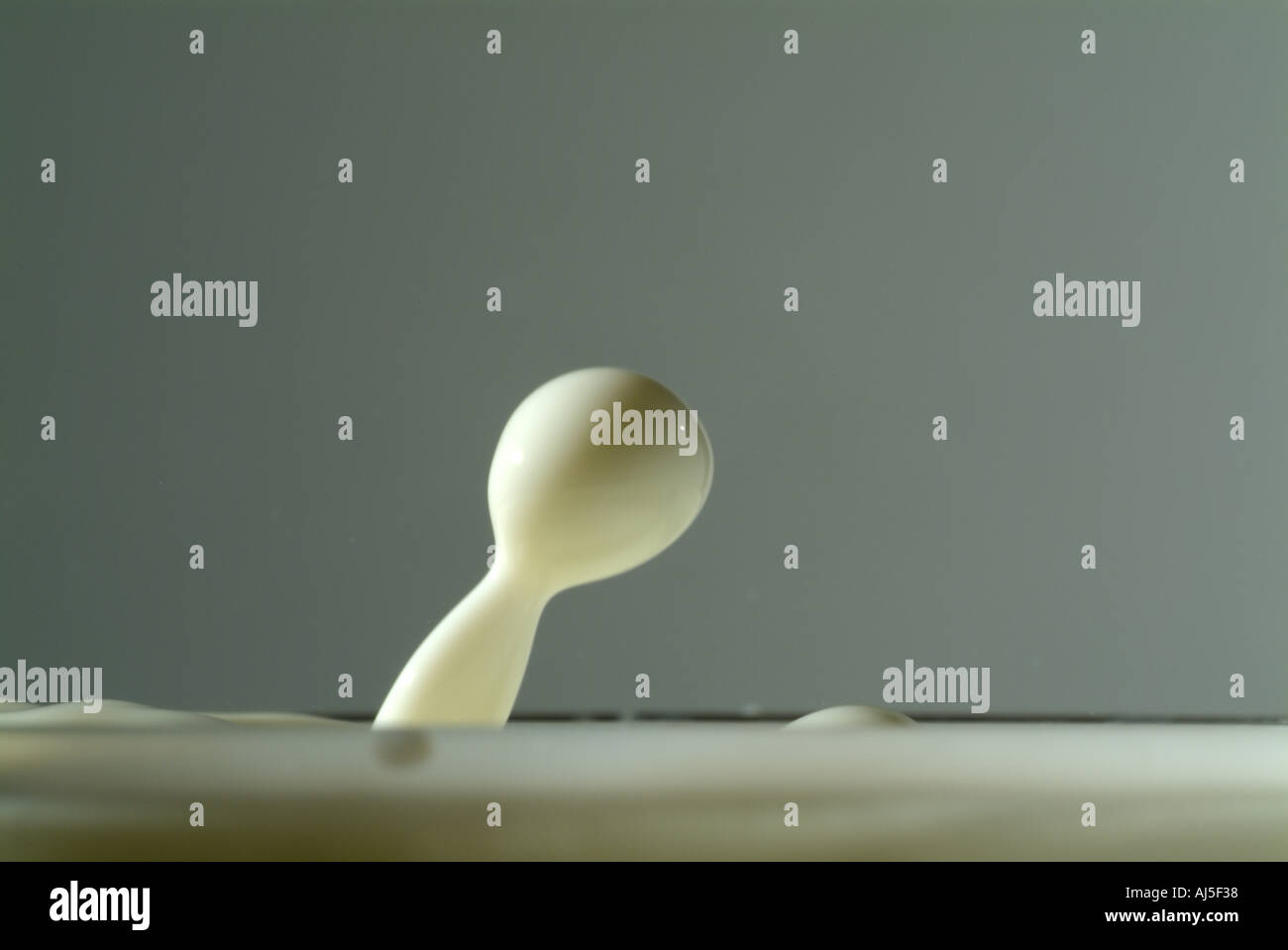 Drop of milk in a glass Stock Photo - Alamy