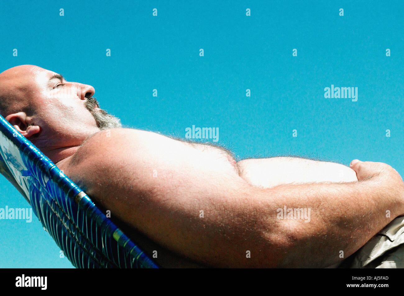 Overweight man sunbathing Stock Photo - Alamy