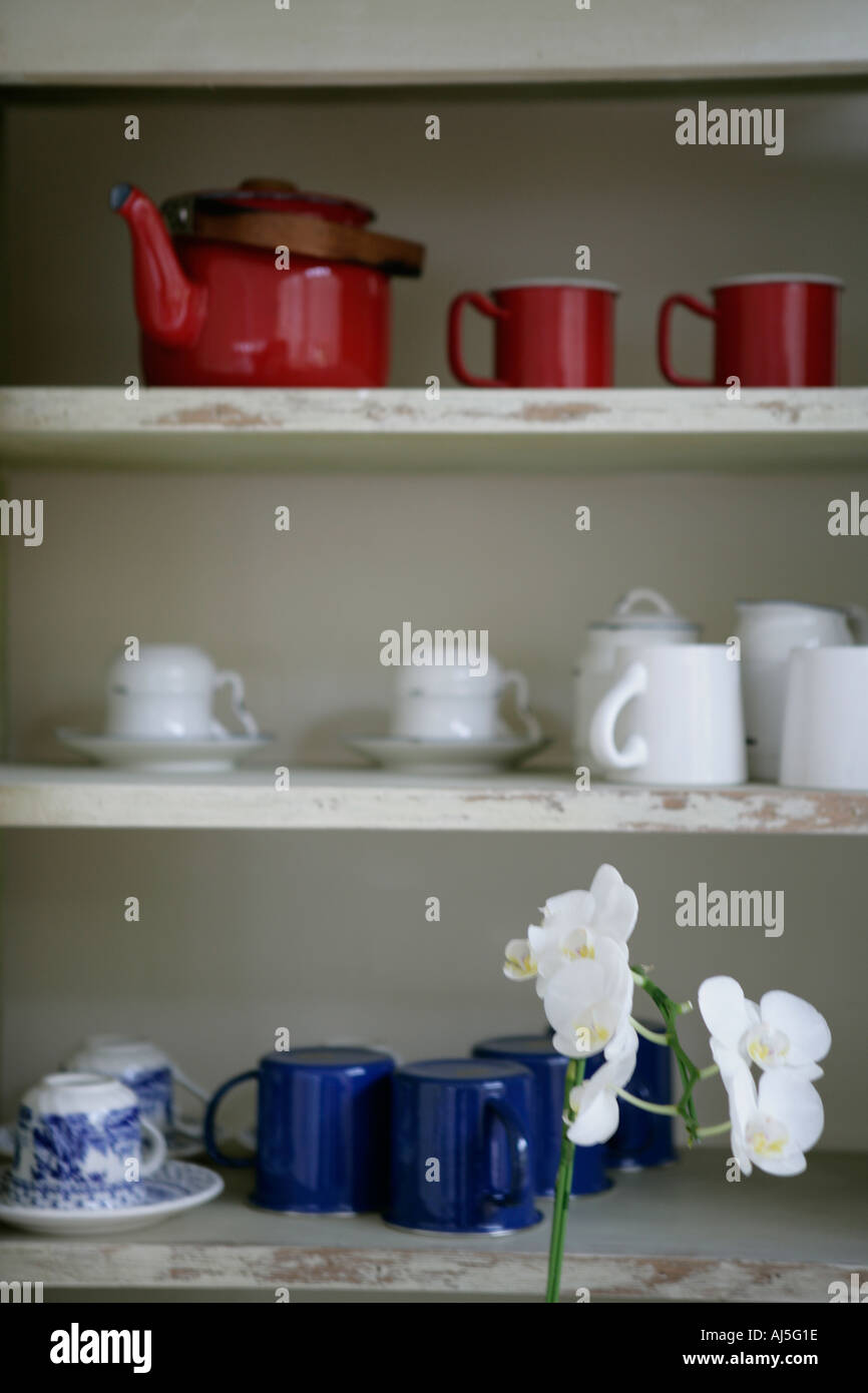 Cups and saucers on shelf Stock Photo - Alamy