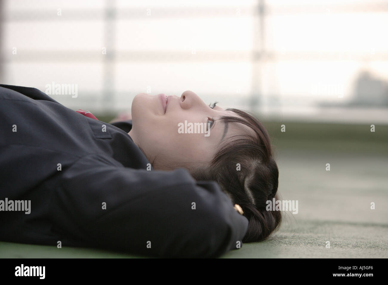 High school girl lying down Stock Photo - Alamy