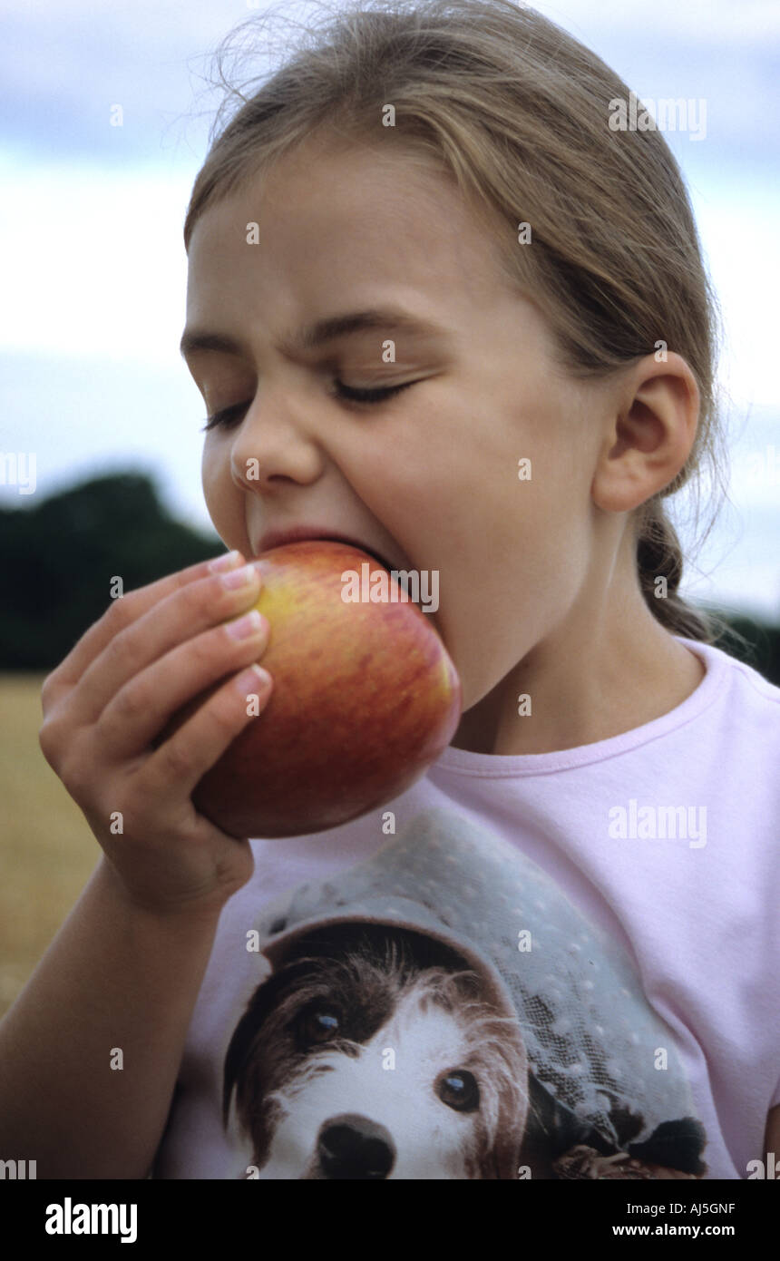 Girl eating apple outdoors biting hi-res stock photography and images ...