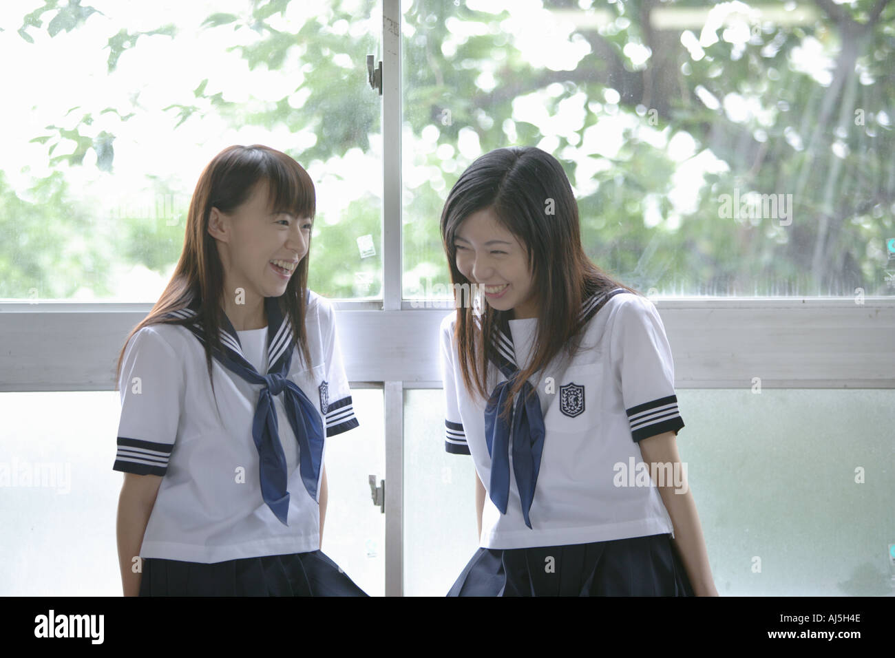 Two high school girls in classroom Stock Photo - Alamy