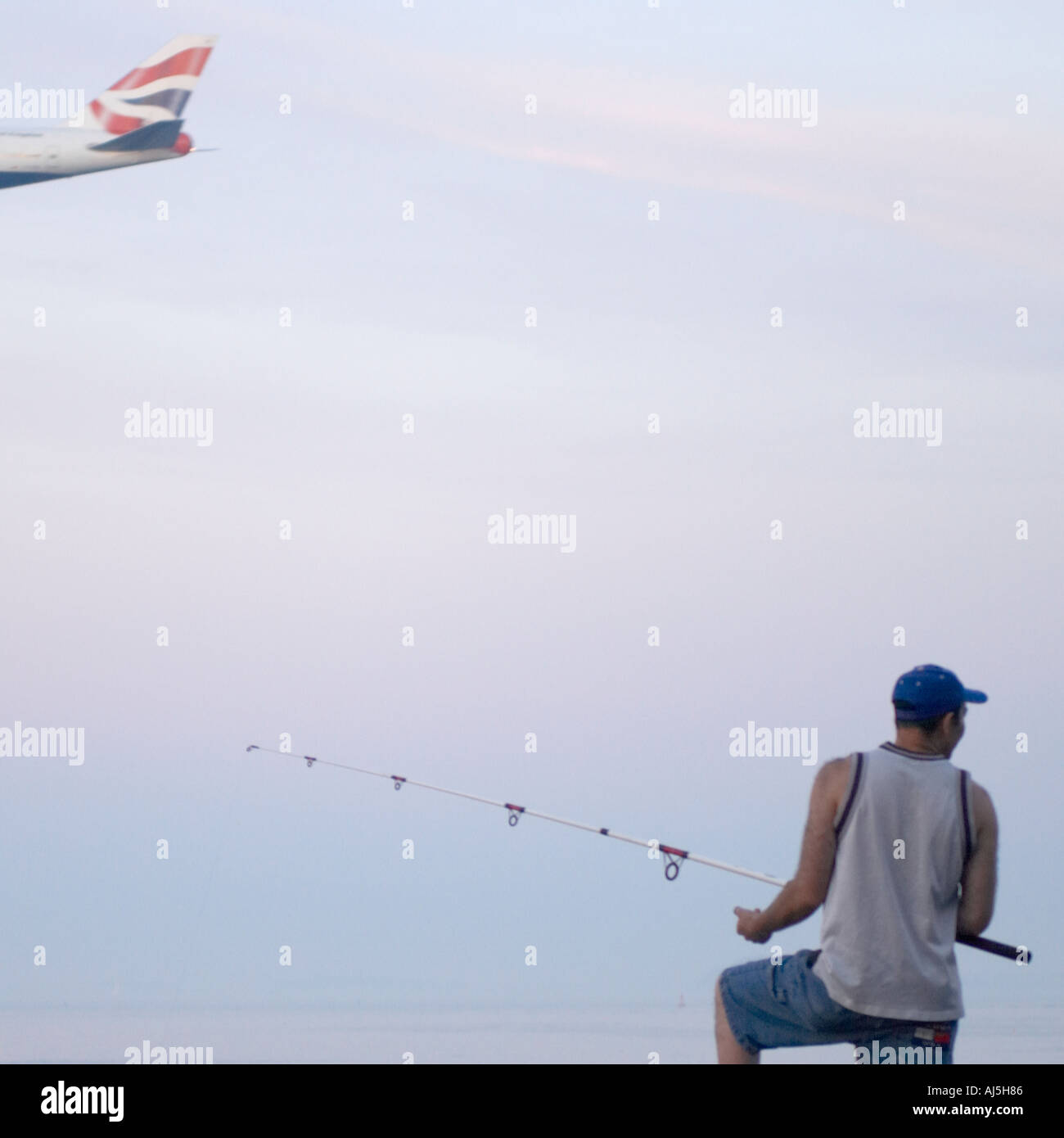 Fisherman with Boeing 747 Landing over Water in Background Stock Photo ...