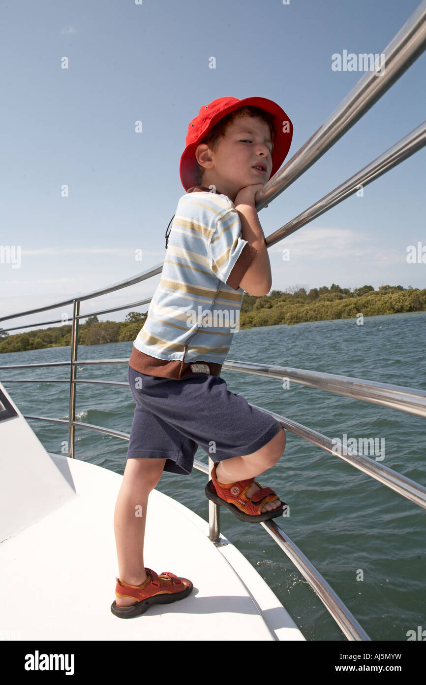 Young boy child standing by cruise boat guard rail on Myall River near ...