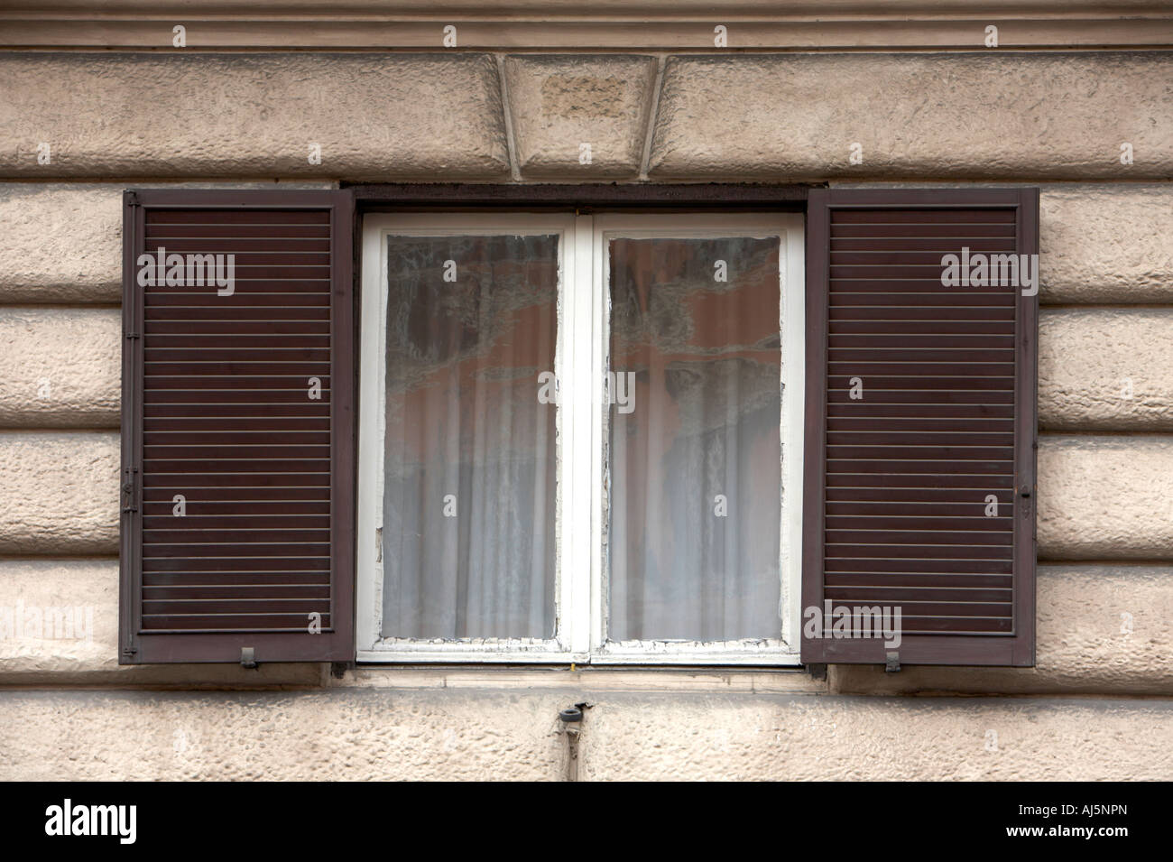 old shuttered window with brown shutters and white frames Rome Lazio ...