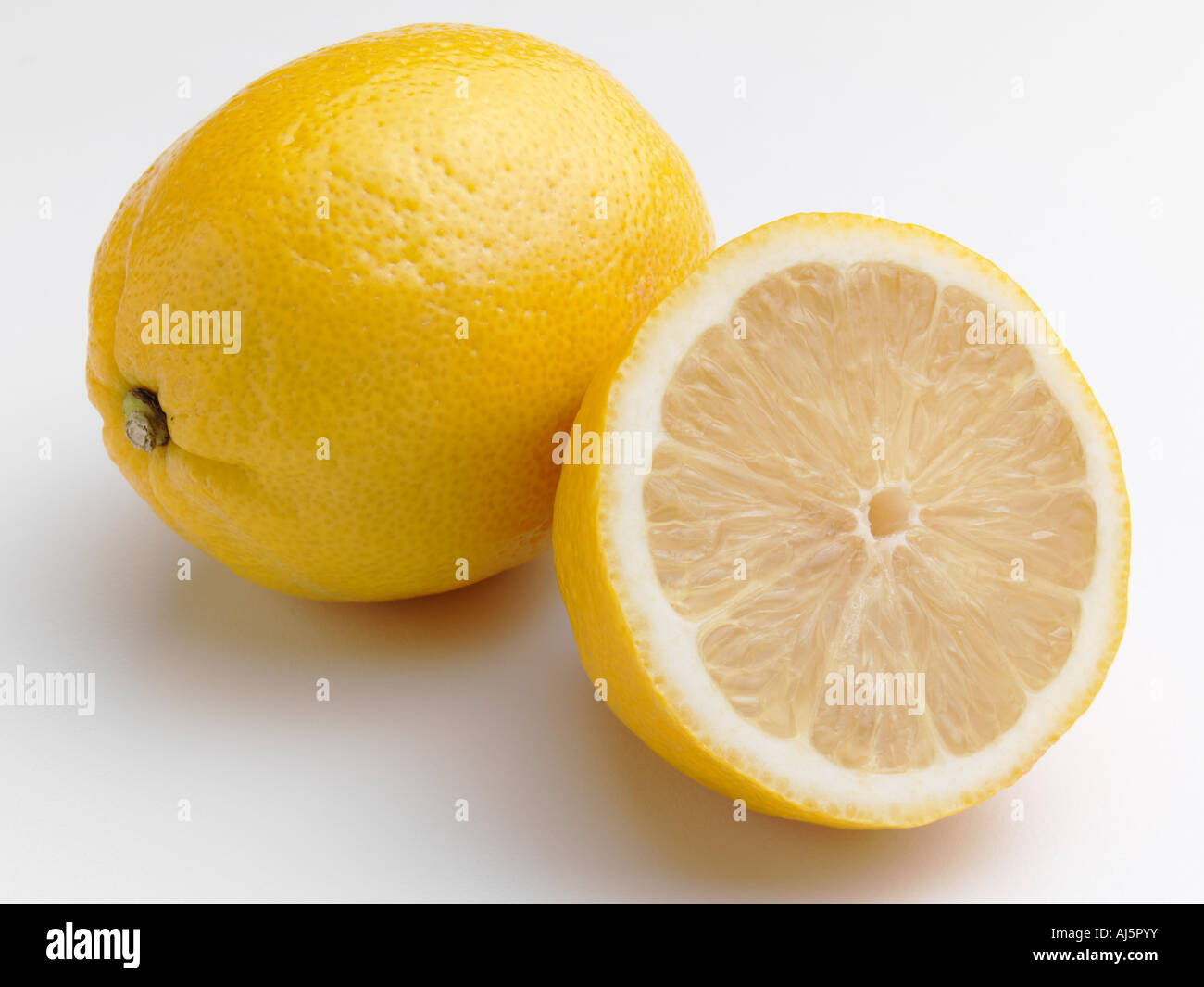 Whole and a cut half lemon on a white background Stock Photo - Alamy