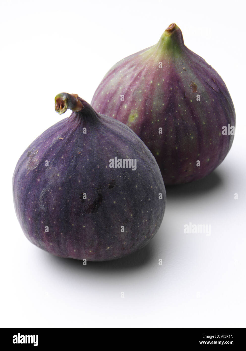 Two whole figs on a white background Stock Photo - Alamy