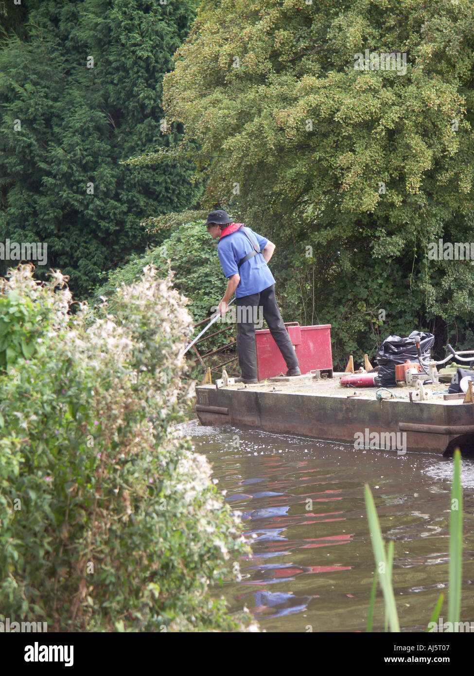 Workers manually clearing litter from a canal in the Midlands Stock ...
