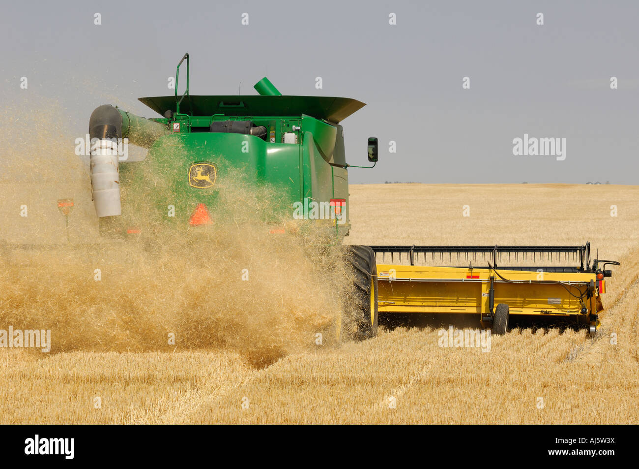 Combine working a field on the Prairies Southern Saskatchewan Canada ...