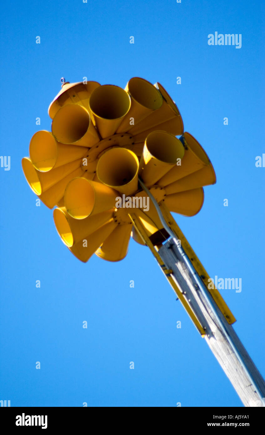 Tornado warning siren in Texas, USA, mounted on a tall pole against a ...
