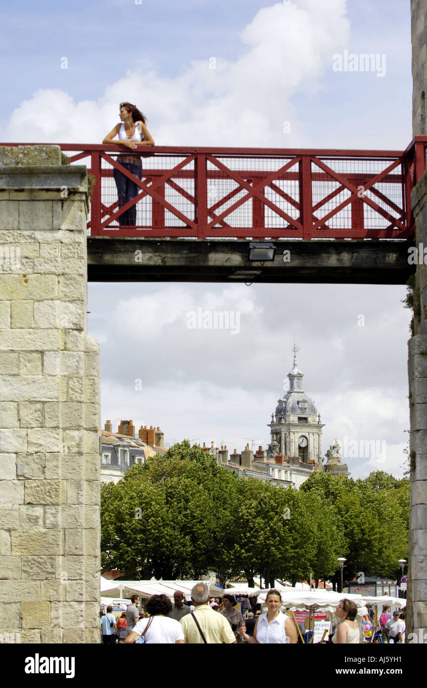 street urban quaint woman on bridge tourists visitors blue sky white ...