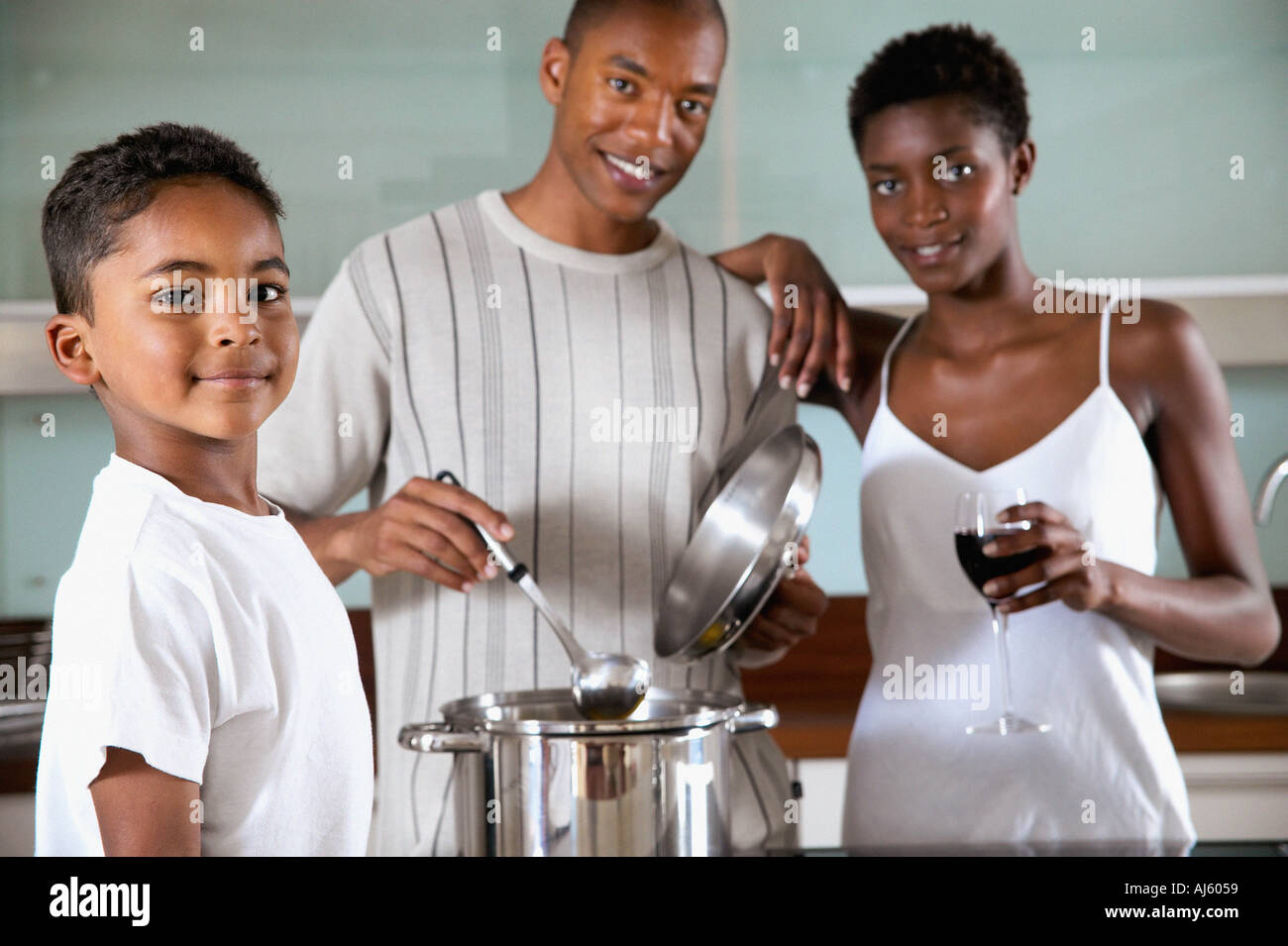 Family in kitchen Stock Photo - Alamy