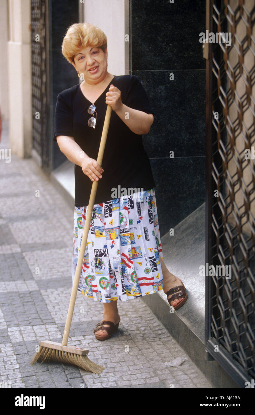 Prague shop keeper sweeping the pavement Stock Photo - Alamy