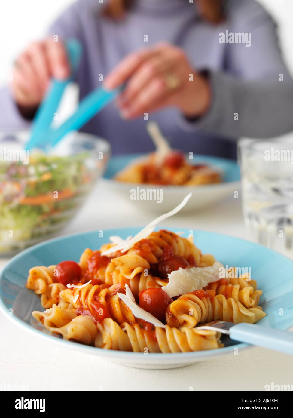 Italian fusilloni pasta lifestyletable setting woman tossing green ...