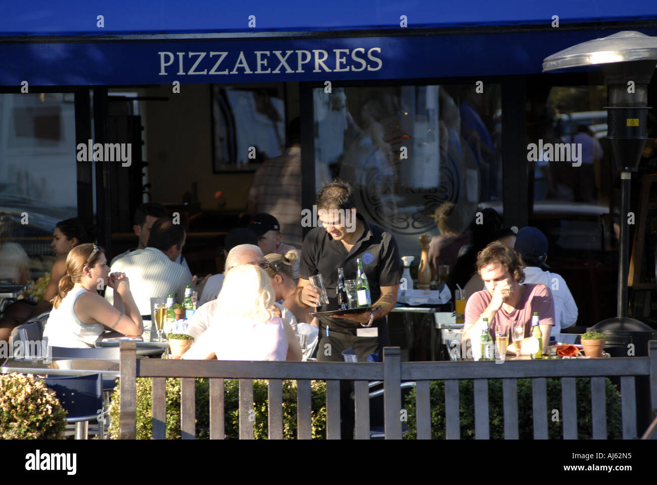 People eating outside a Pizza Express in Belsize Park London Stock ...