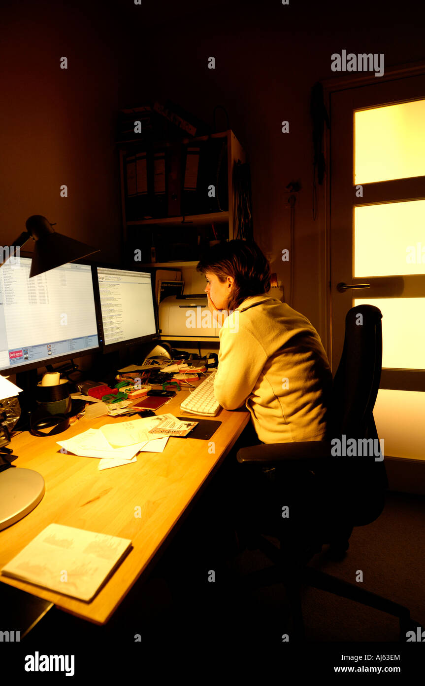 Late working women at home in the evening Stock Photo - Alamy