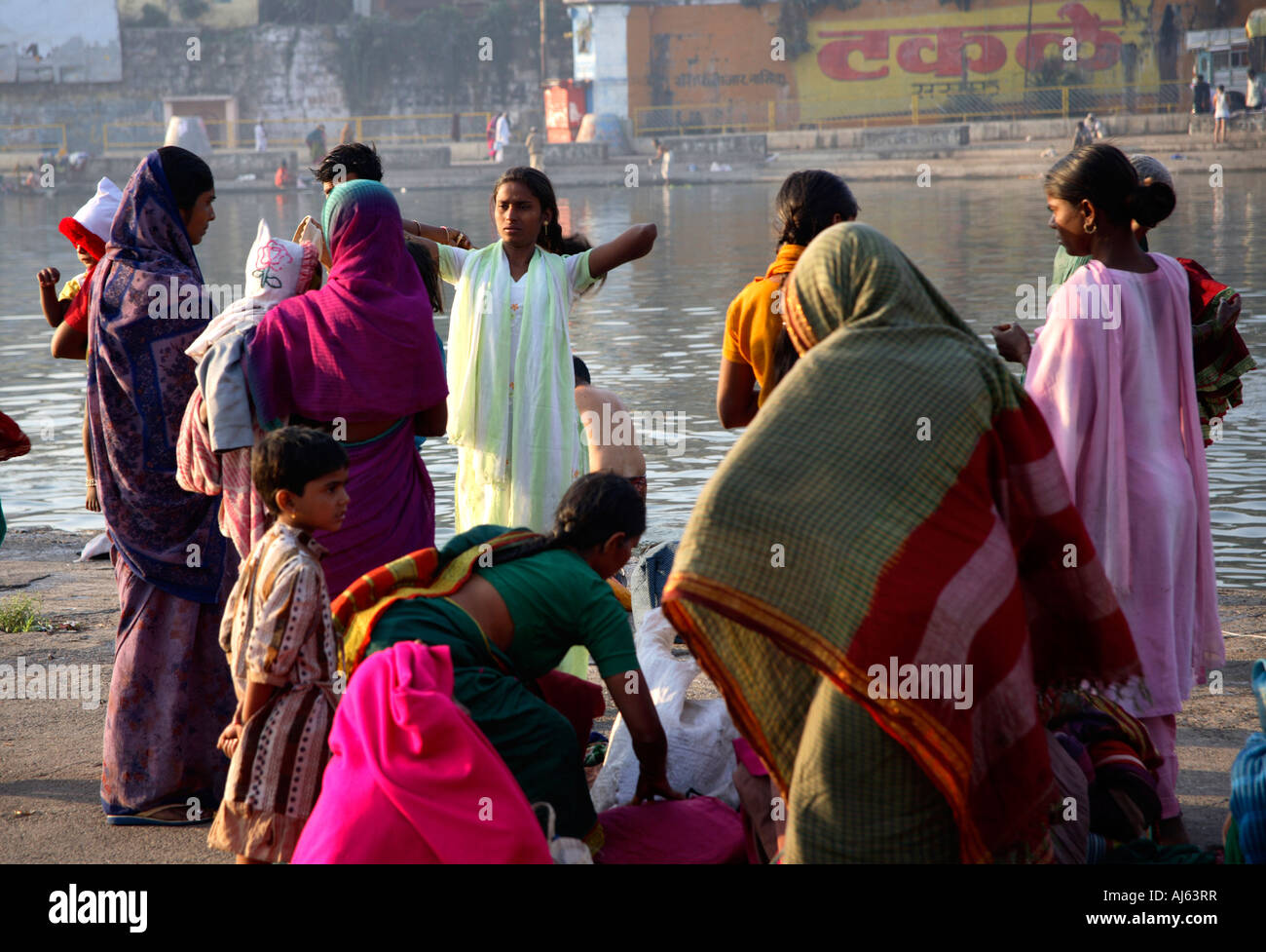 Indian females preparing for morning ablution at the bathing tank at ...
