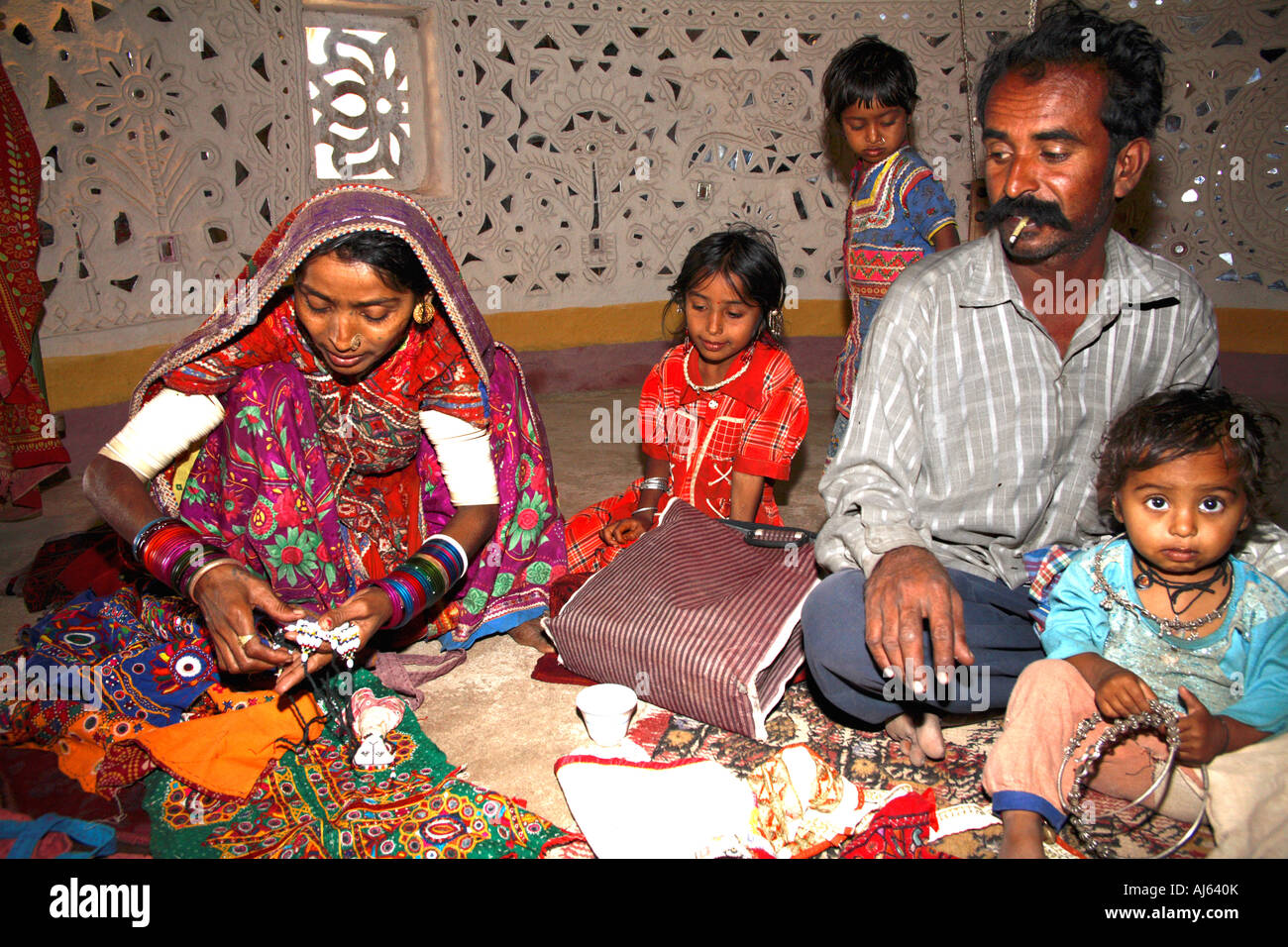 Harijan Tribal parents with young children in mud hut in Ludia Village ...