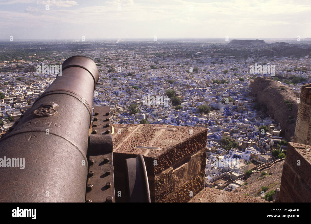 Overview of the blue city of Jodhpur from the fort with an old cannon ...