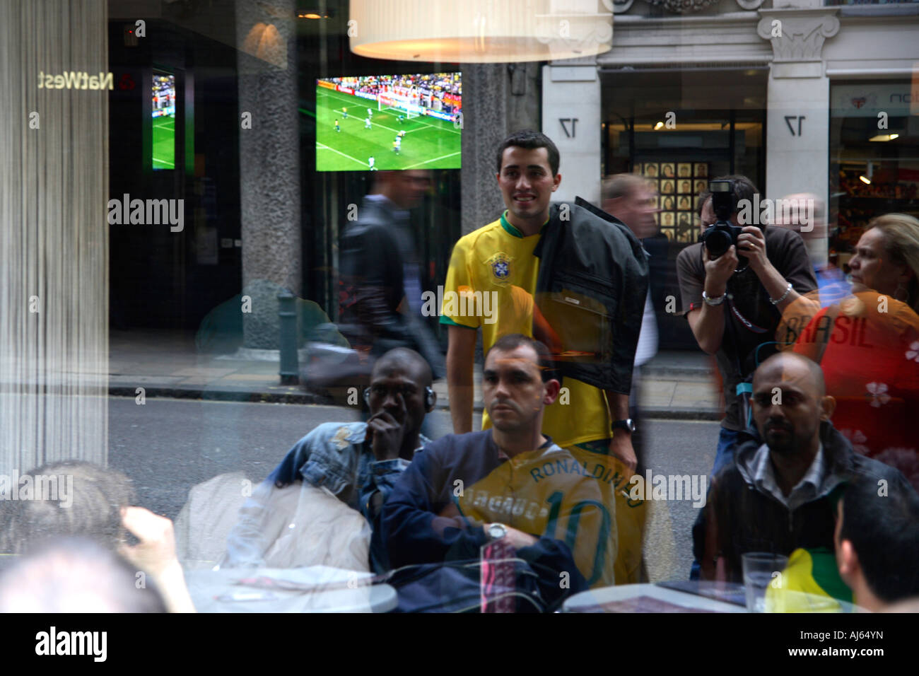 Brazilian fan watching match vs Ghana through bar window, Soho, London ...