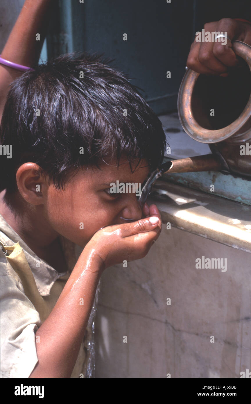 Boy Drinking From Tap India Stock Photo - Alamy