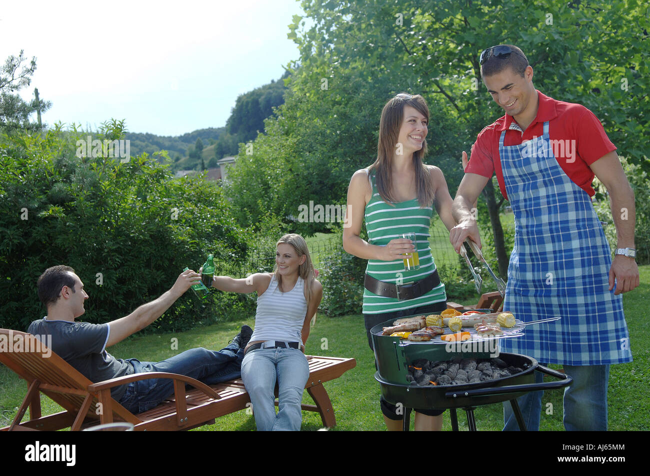 young people having a barbecue Stock Photo - Alamy