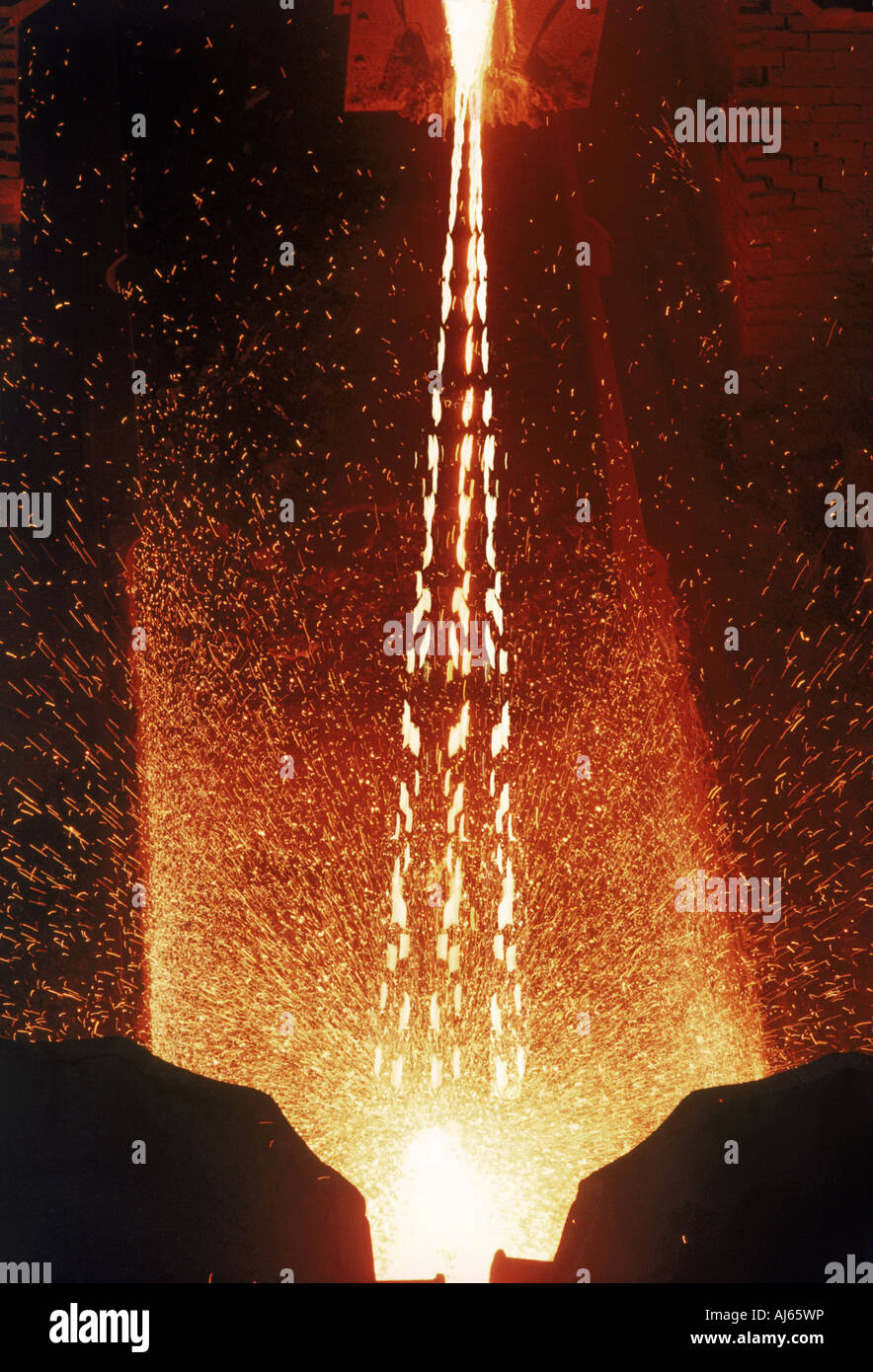 Pouring molten steel from melting pot to ladle Stock Photo - Alamy