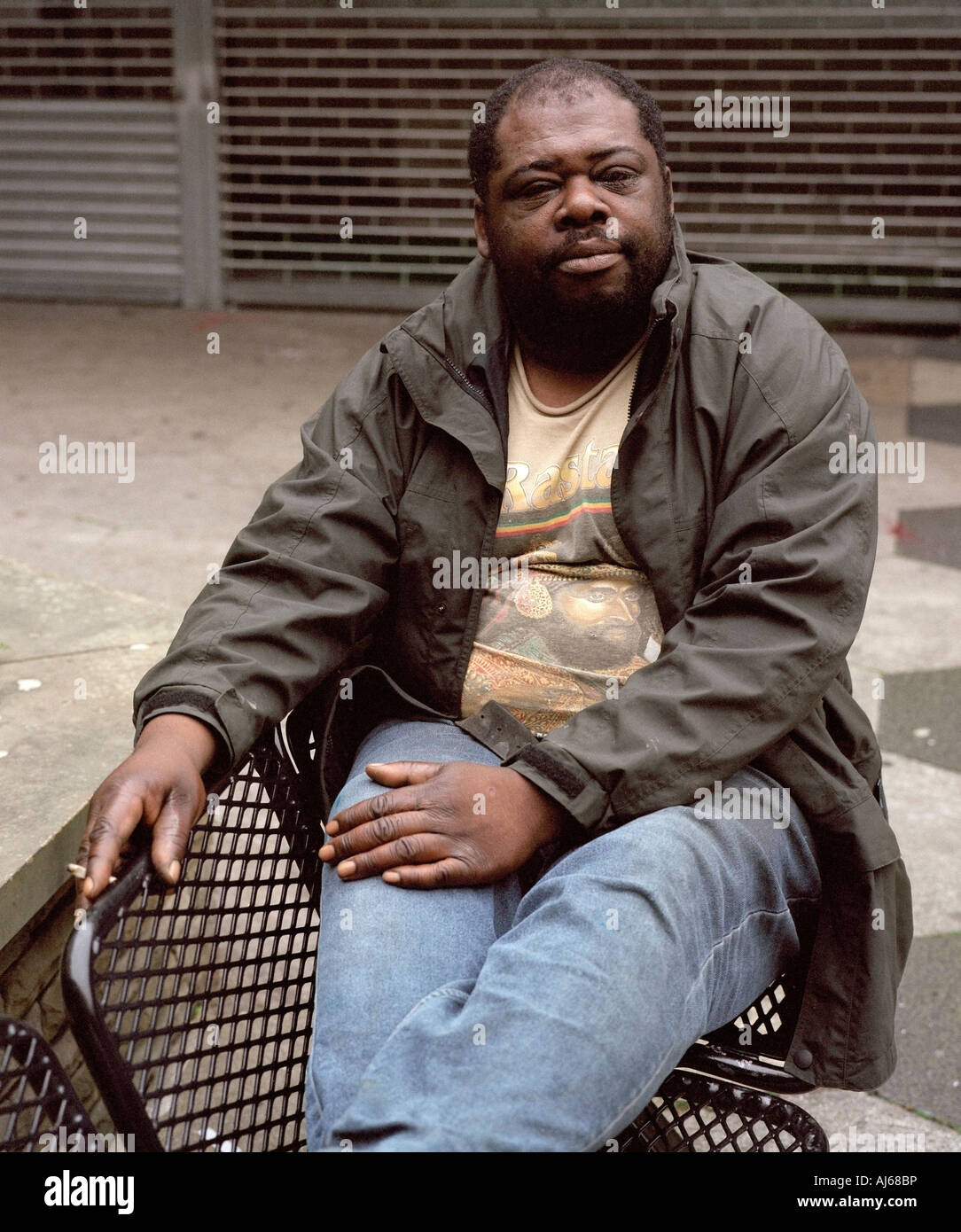 A west Indian man laying on a bench, London, England, UK Stock Photo ...