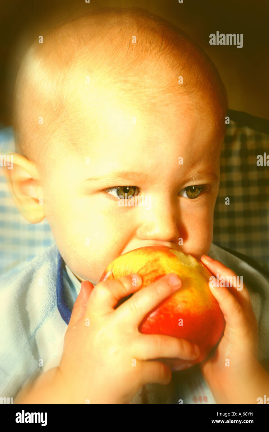 little boy eating apple Stock Photo - Alamy