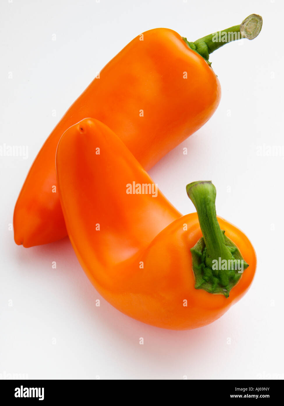 orange sweet peppers on a white background Stock Photo - Alamy