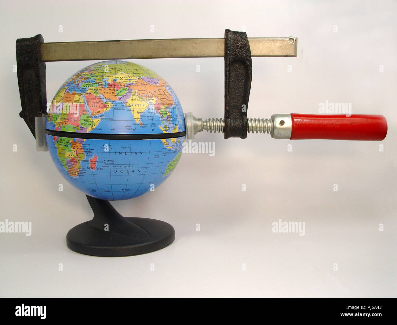 Globe with fastening clamp as symbol for the globe under pressure ...