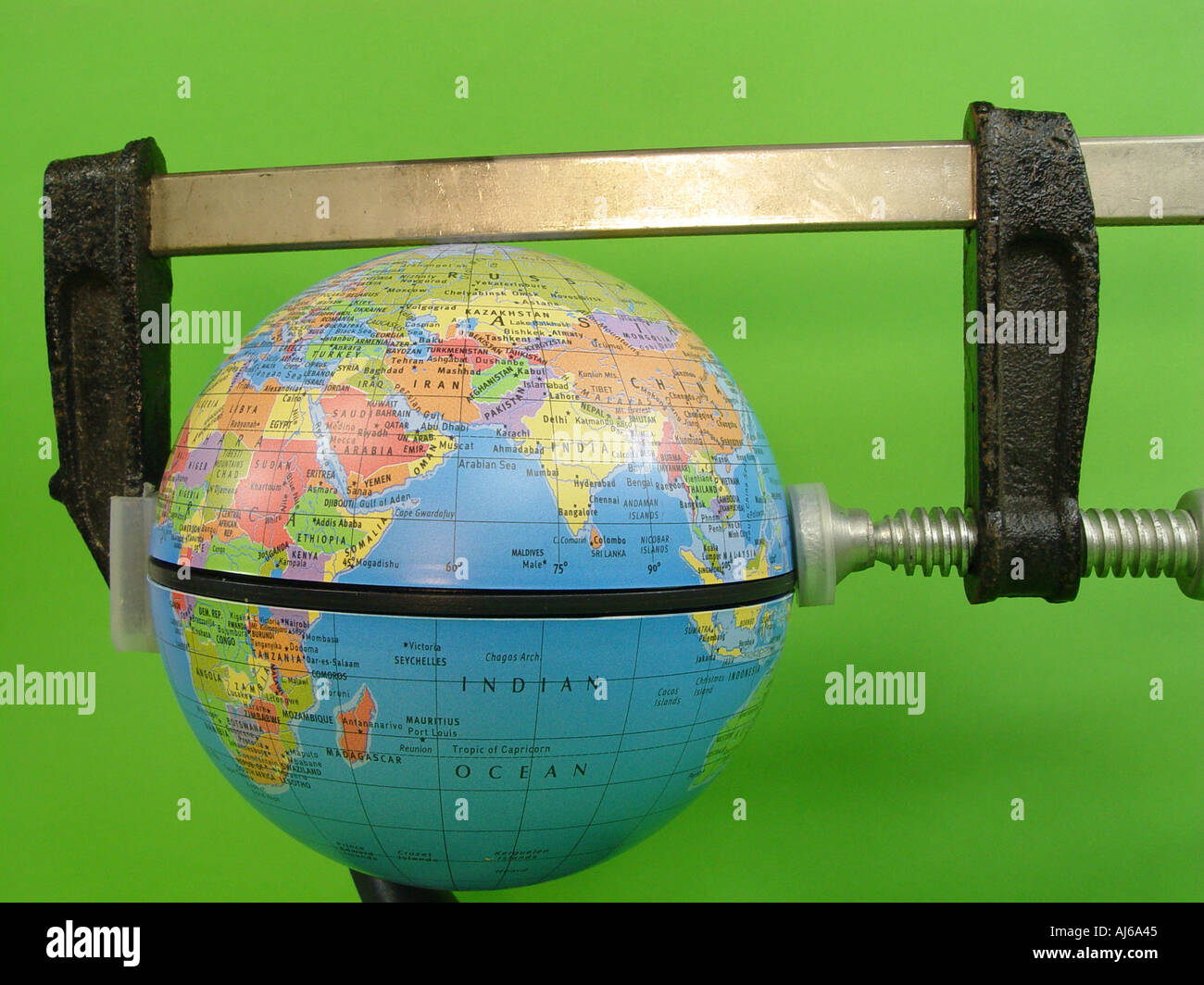 Globe with fastening clamp as symbol for the globe under pressure ...