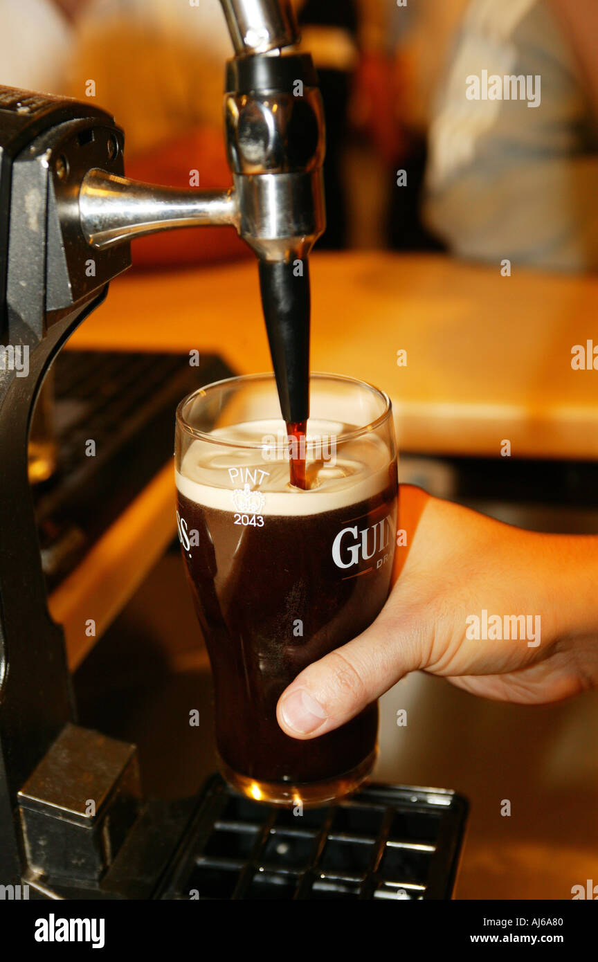 Guinness being poured with a shamrock Stock Photo - Alamy