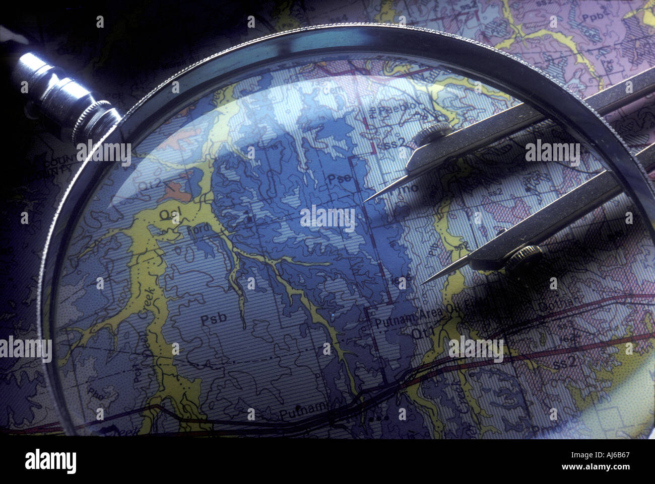Close up of map with magnifying glass and dividers Stock Photo - Alamy