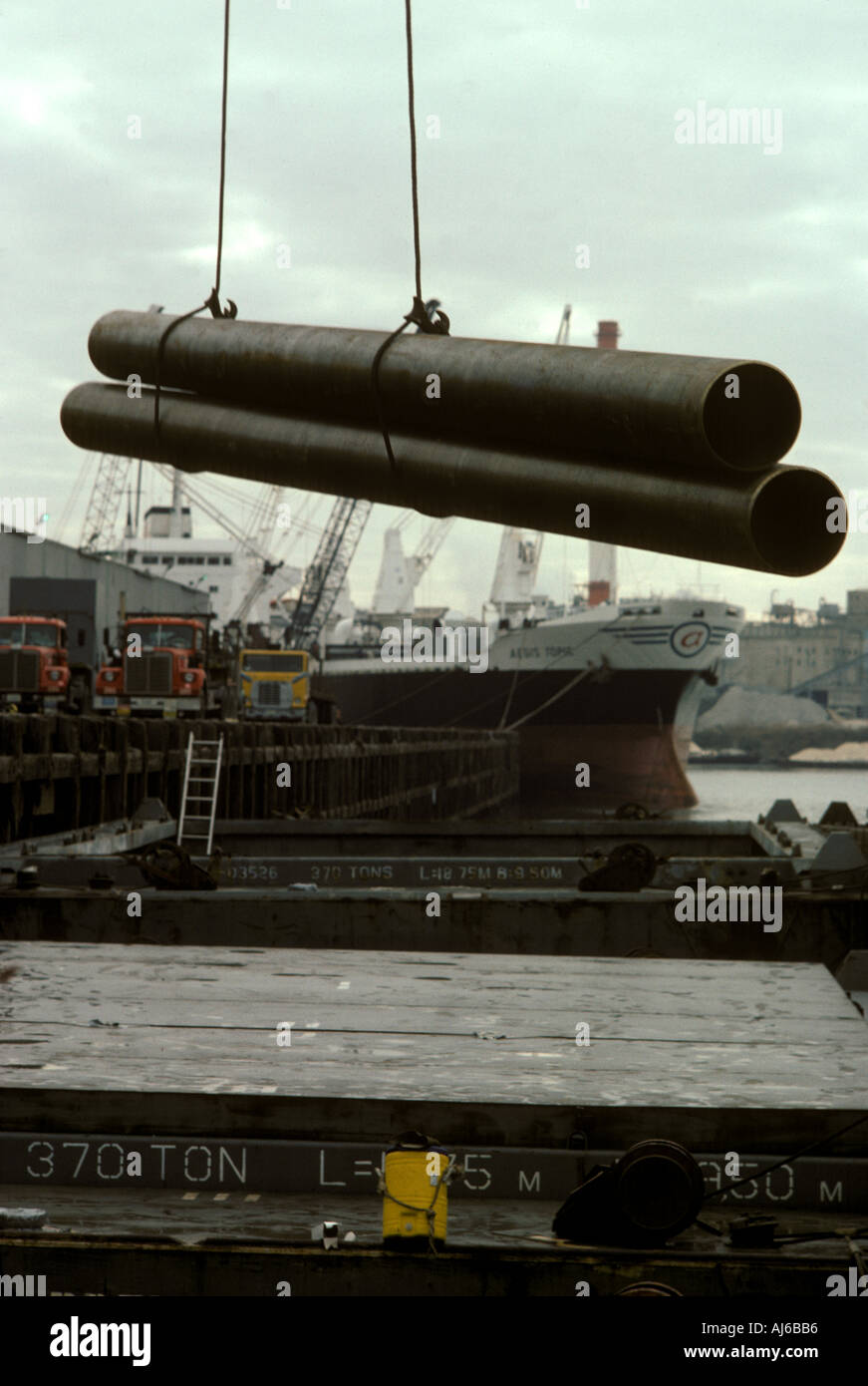 Pipe being loaded off ship in ship channel in Houston Texas Stock Photo ...
