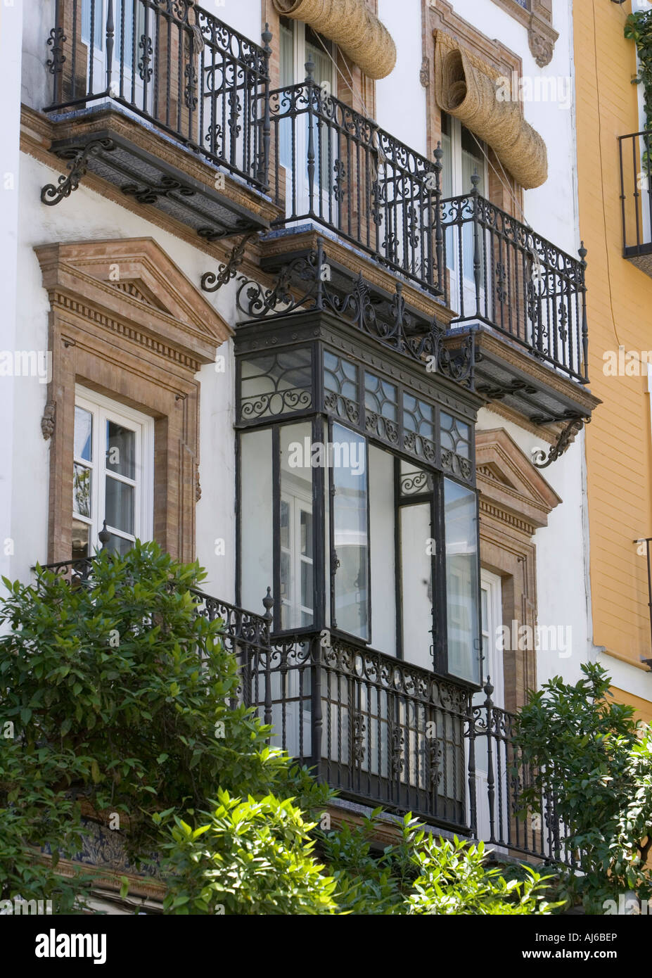Open and enclosed balconies on a residential street in Seville Spain ...