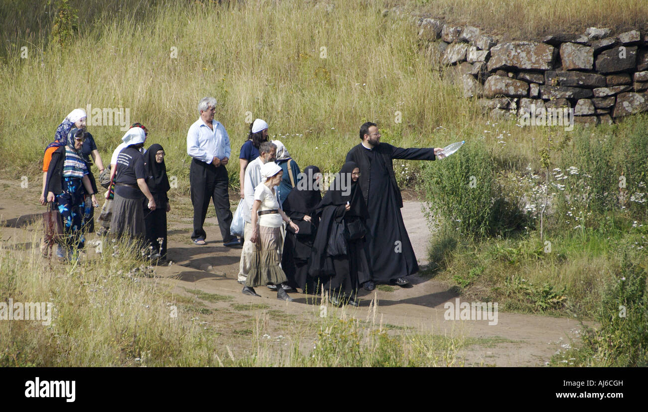 Monk showing the way to the group of pilgrims Valaam Russia Stock Photo ...