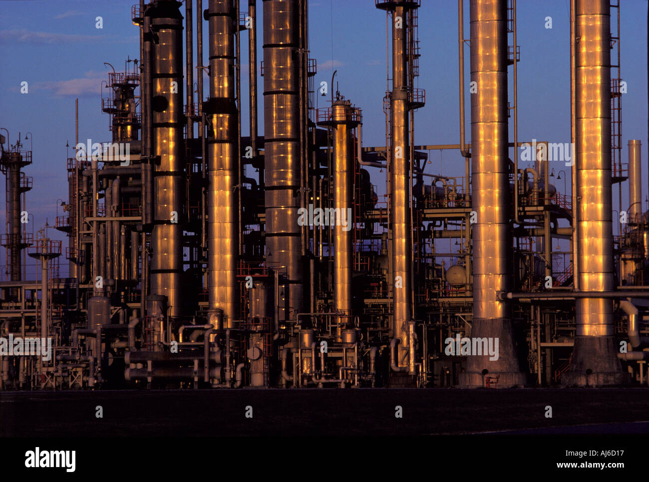 Chemical plant towers at sunset Stock Photo - Alamy