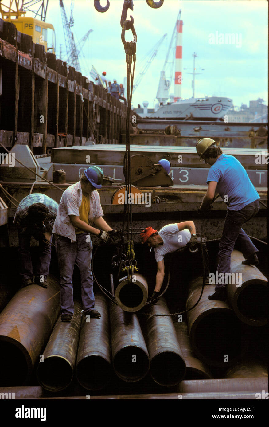 Dock workers unloading pipe at the port of Houston Texas Stock Photo ...
