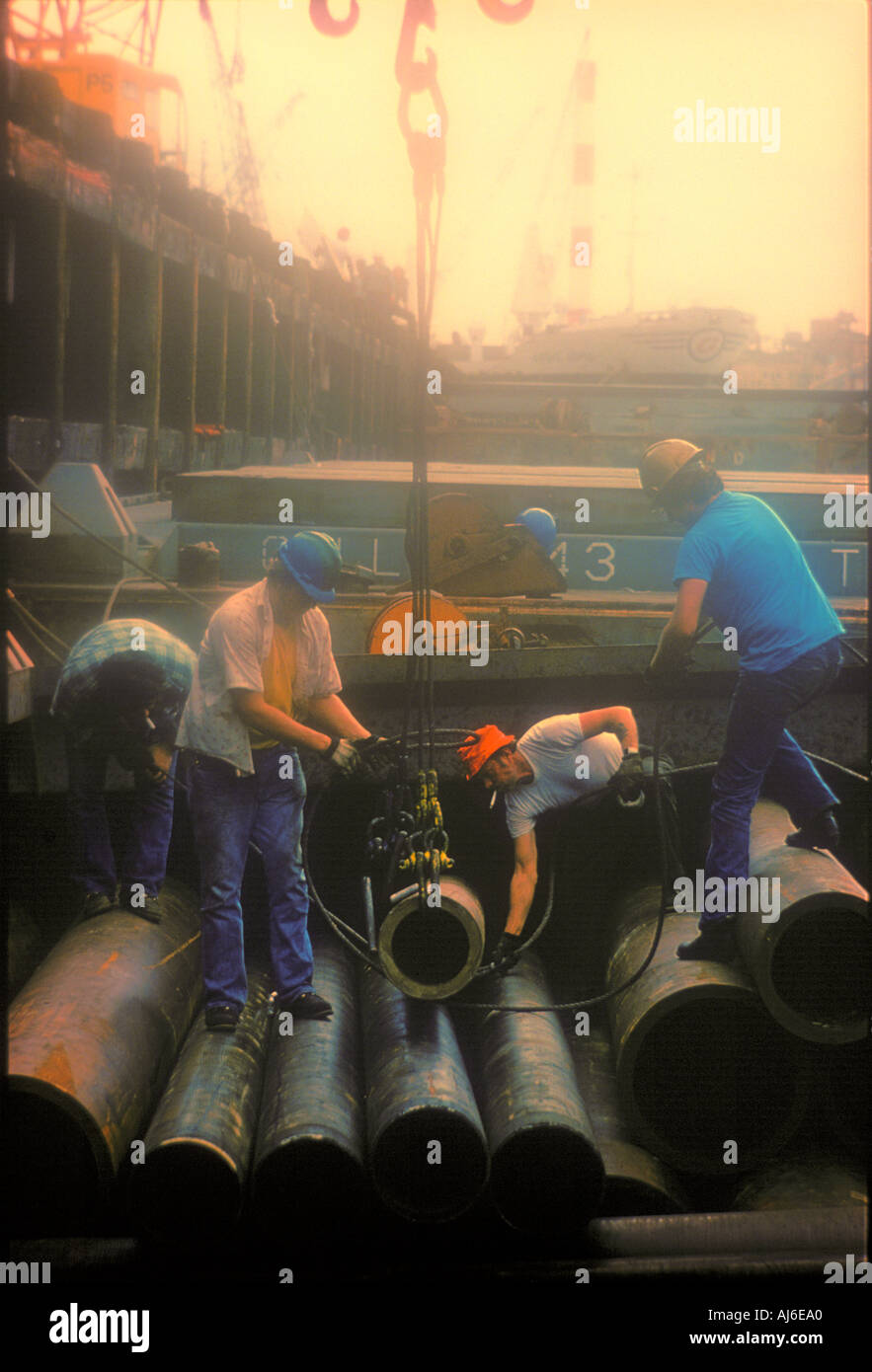 Dock workers unloading pipe at the port of Houston Texas Stock Photo ...