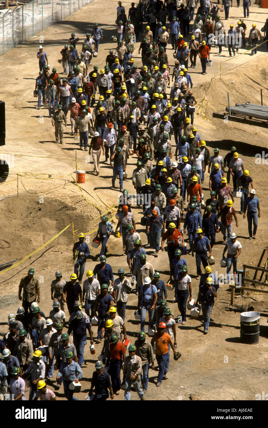 Long line of workers in hard hats leaving work Stock Photo - Alamy