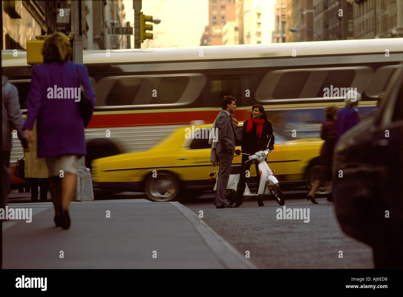 Couple with Honda scooter in New York with bus and taxi Stock Photo - Alamy