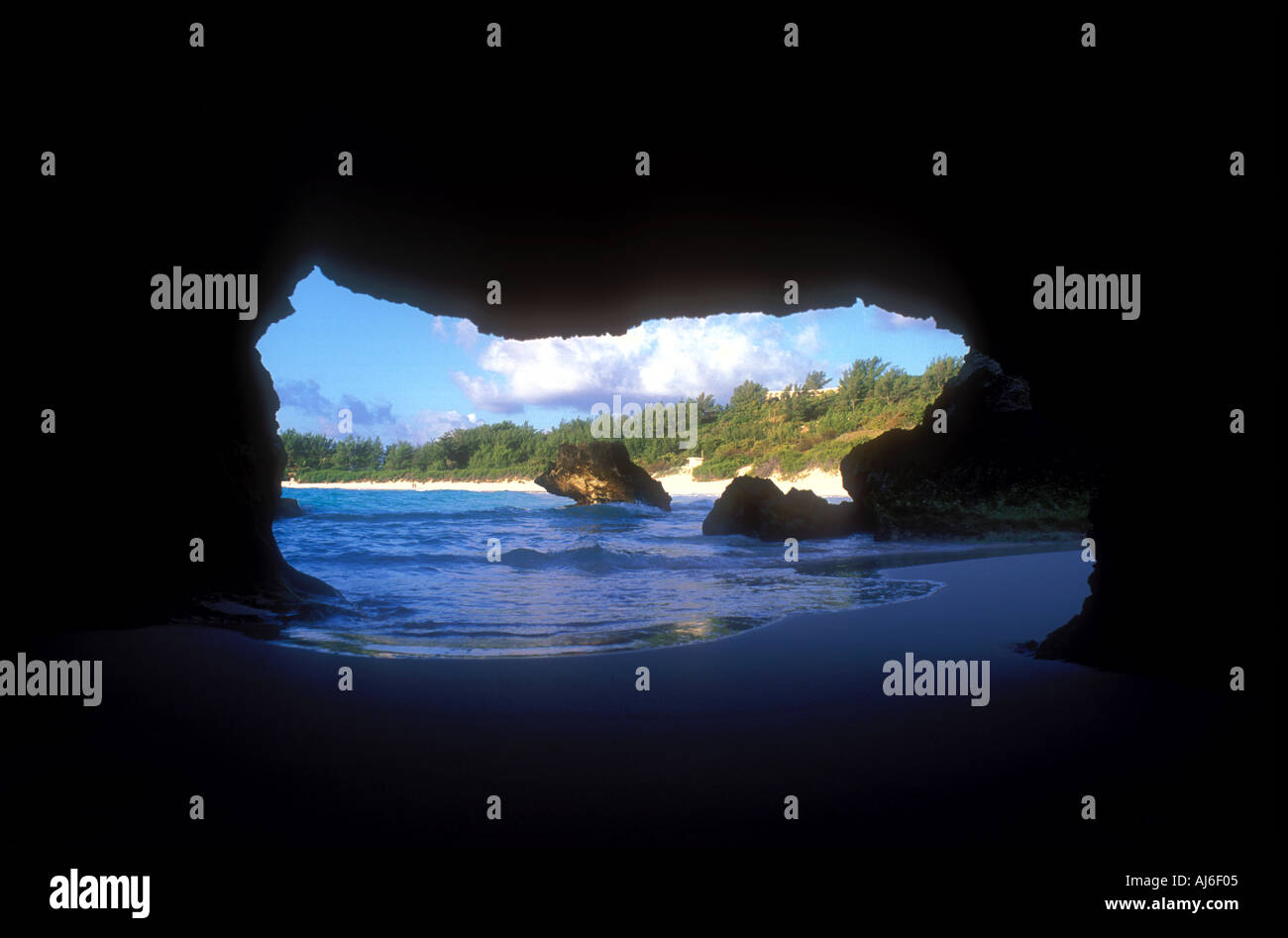 View through stone arch of Horseshoe Bay and beach on the island of ...